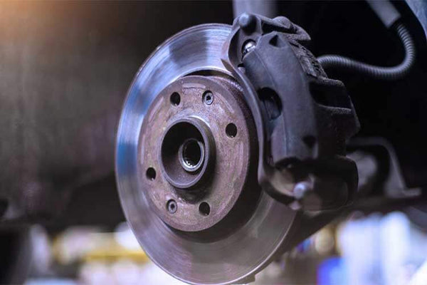 What is the function of the caliper in the car brake